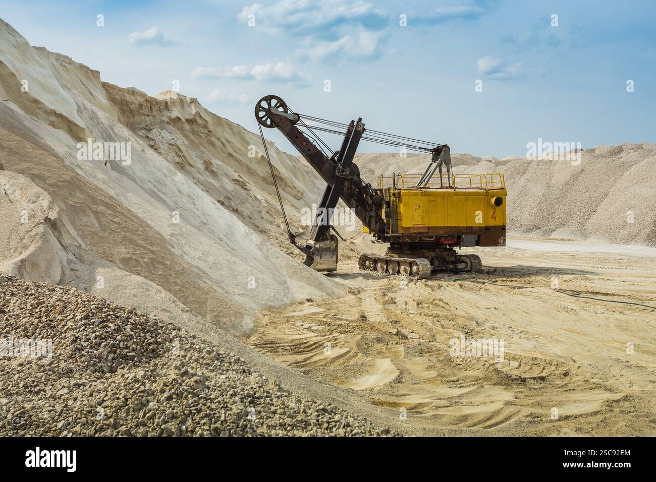 Old yellow dredge in sandy to career Stock Photo - Alamy