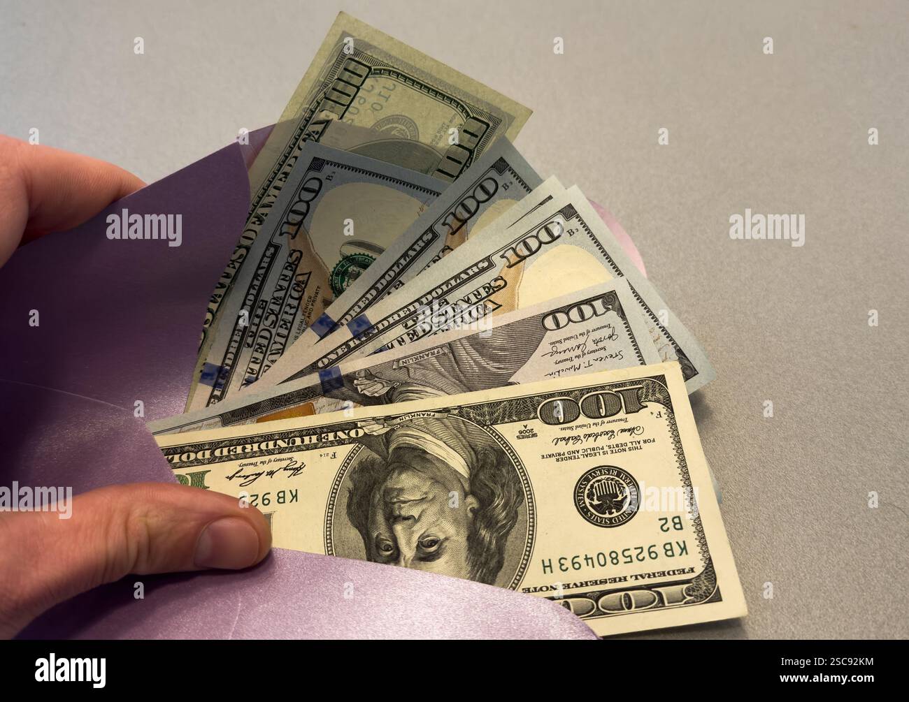 Man hold us money, counting one hundred dollar bills. Saving concept ...