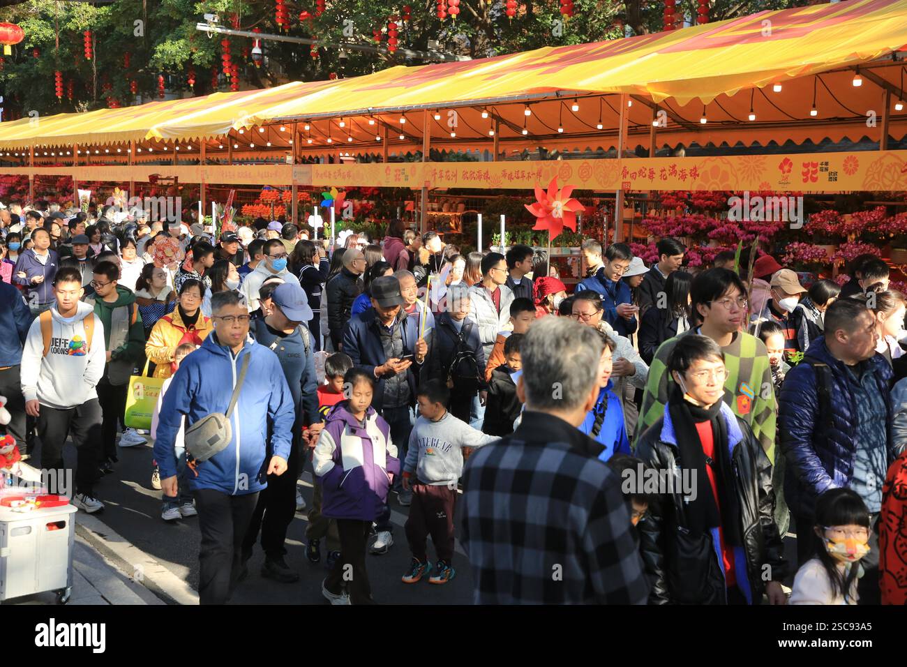 Tourists stroll in the flower street in Guangzhou City, south China's ...