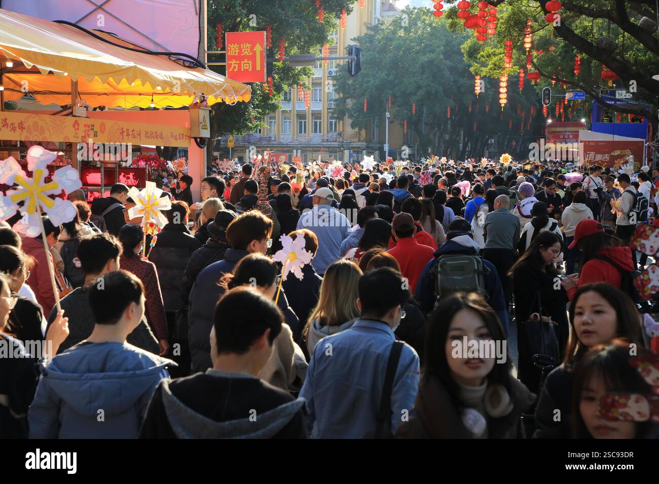 Tourists stroll in the flower street in Guangzhou City, south China's ...