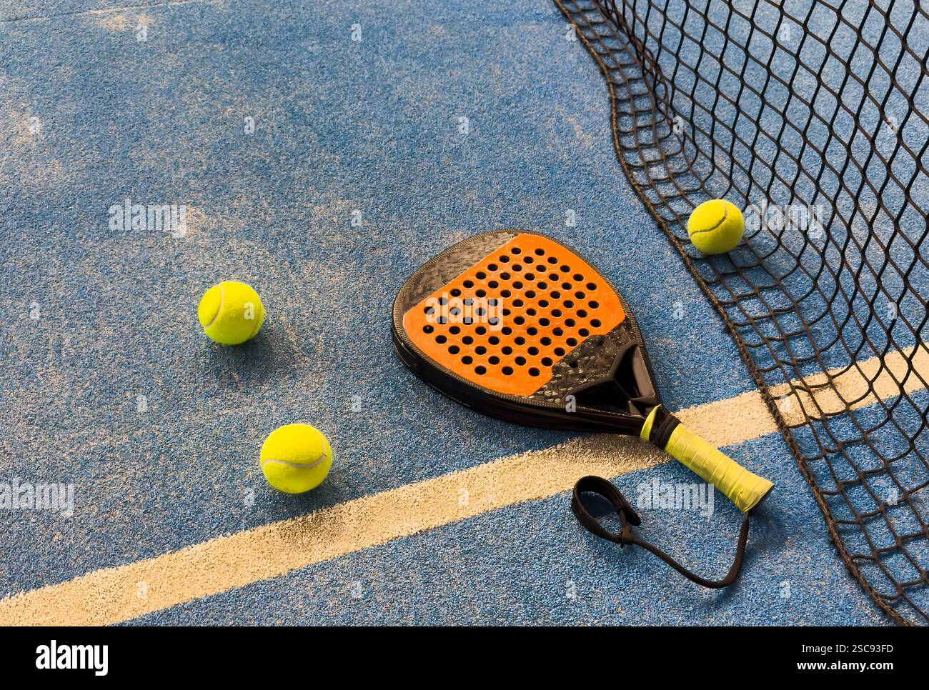 padel racket and yellow balls placed on court near net Stock Photo - Alamy