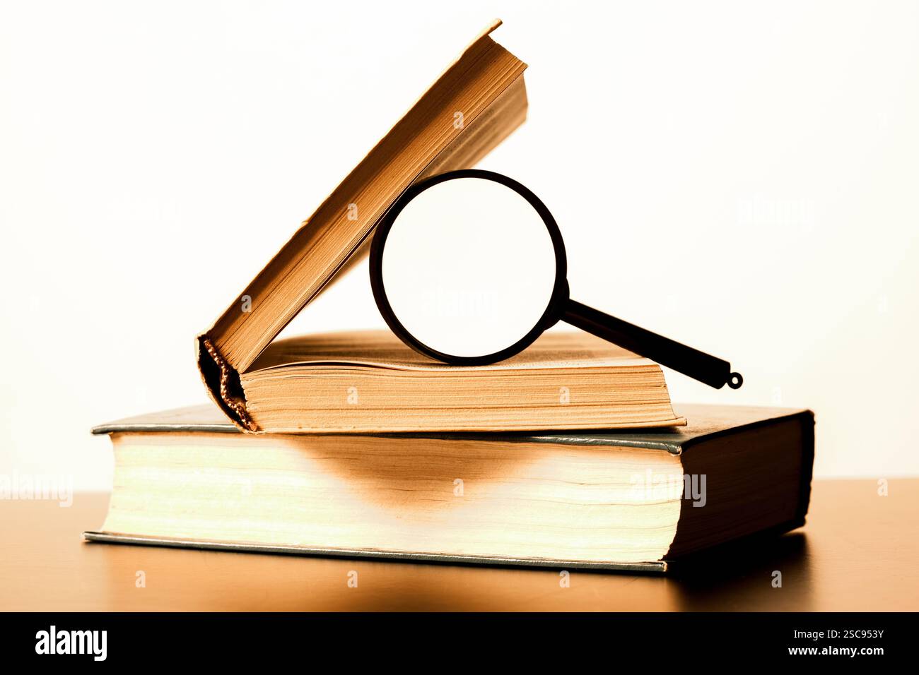 books and magnifying glass Stock Photo - Alamy