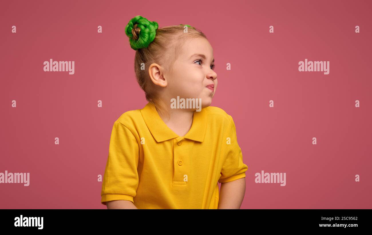 Portrait of playful child, preschool girl in yellow shirt and braided ...