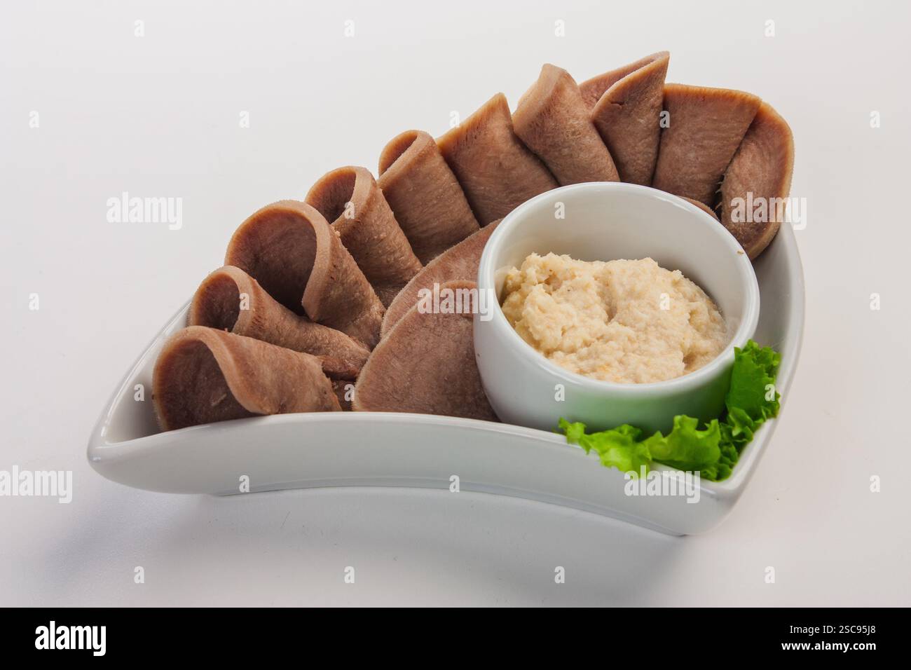 Boiled beef tongue with horseradish sauce and salad Stock Photo - Alamy