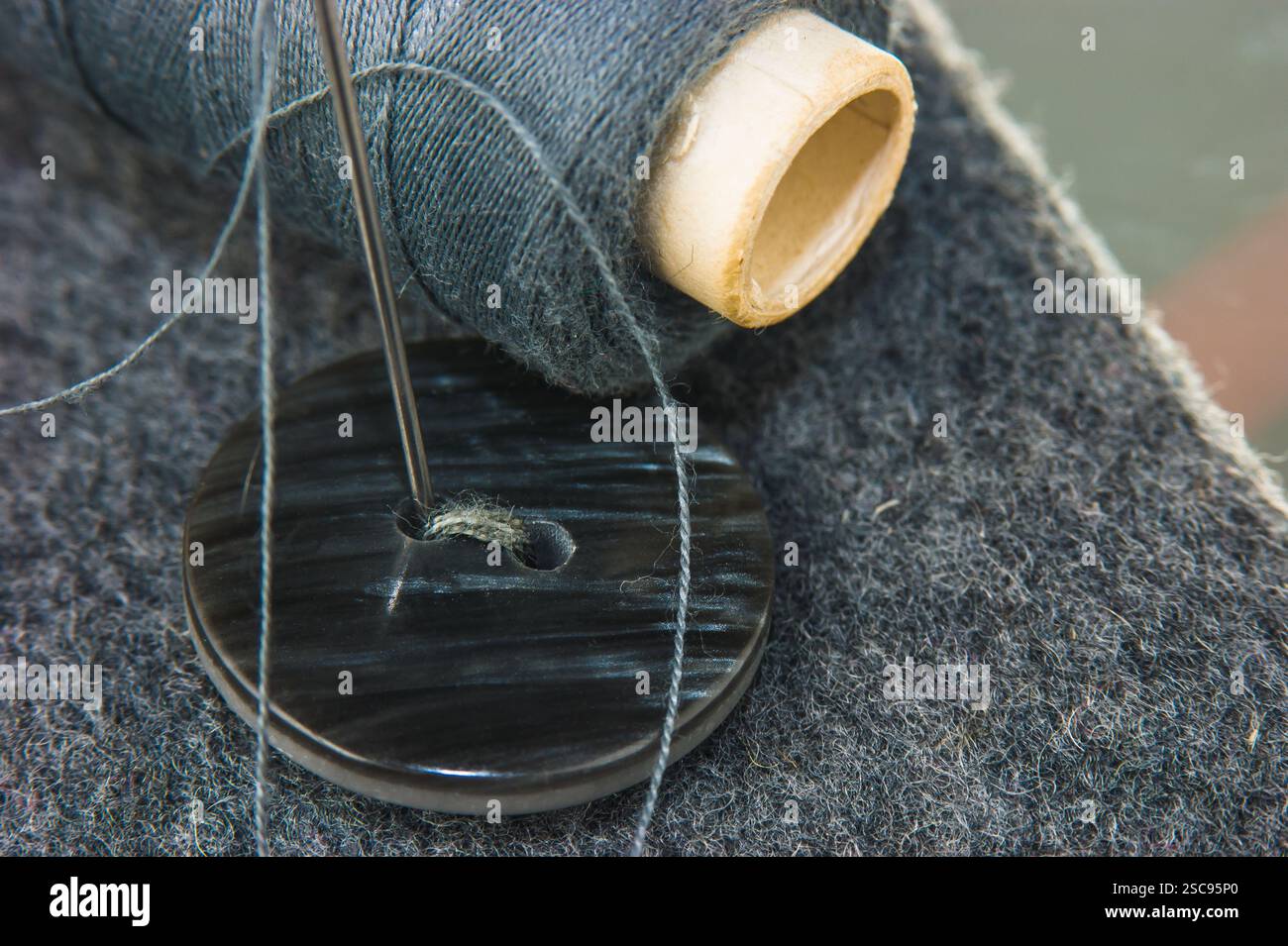 Button pinned the needle to the reel of thread Stock Photo - Alamy