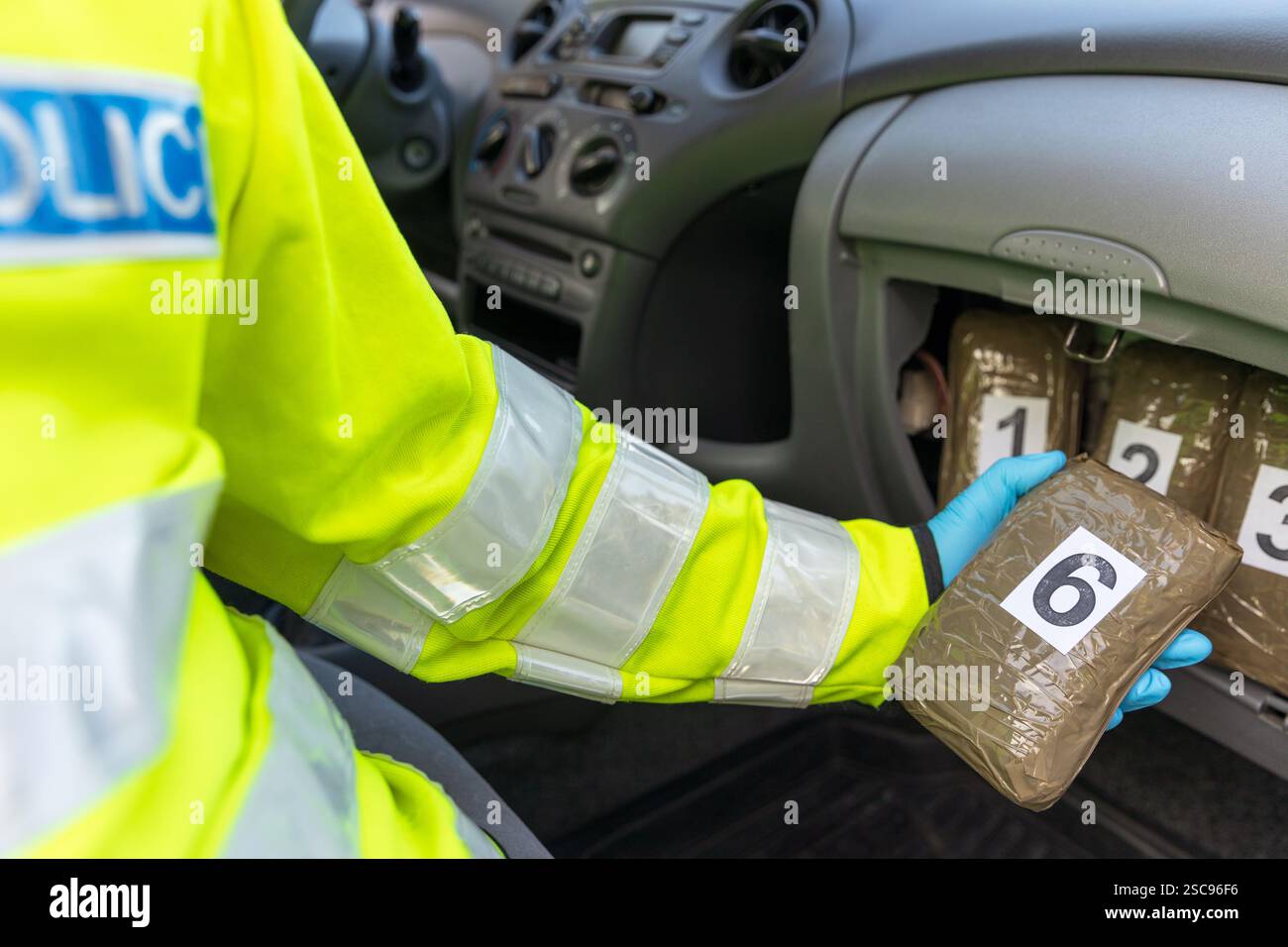 Police officer uncovers drug packages hidden inside a car glove ...