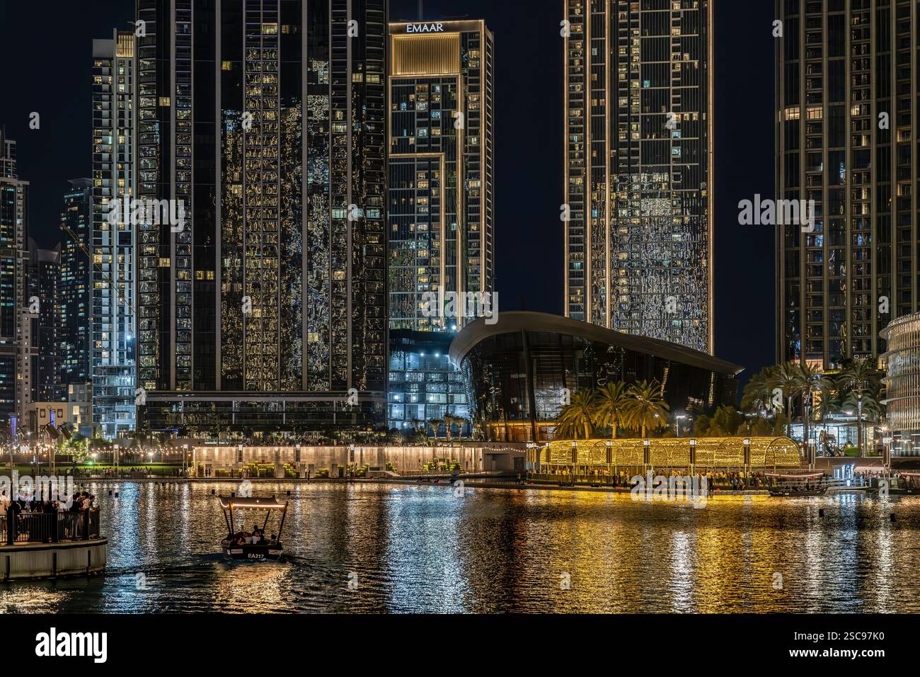 Dubai Opera House on Burj Khalifa Lake. Surrounded by twinkling ...