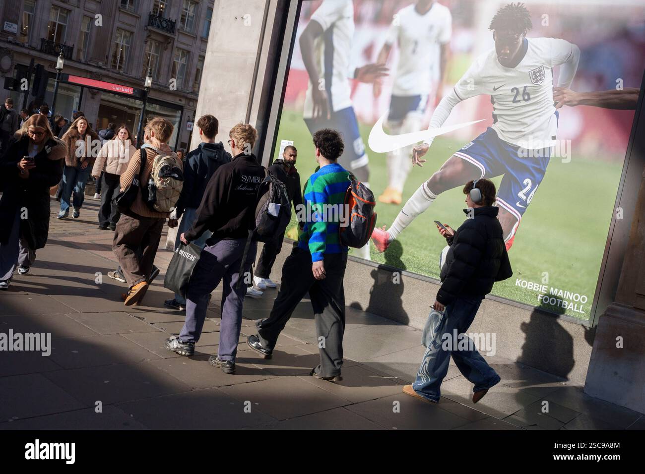 West End shoppers walk past a 'Just Do It' ad slogan that features ...