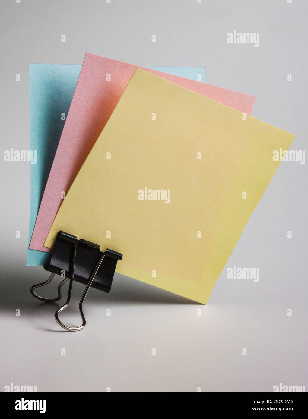 Paper notes on a stand on white background Stock Photo - Alamy