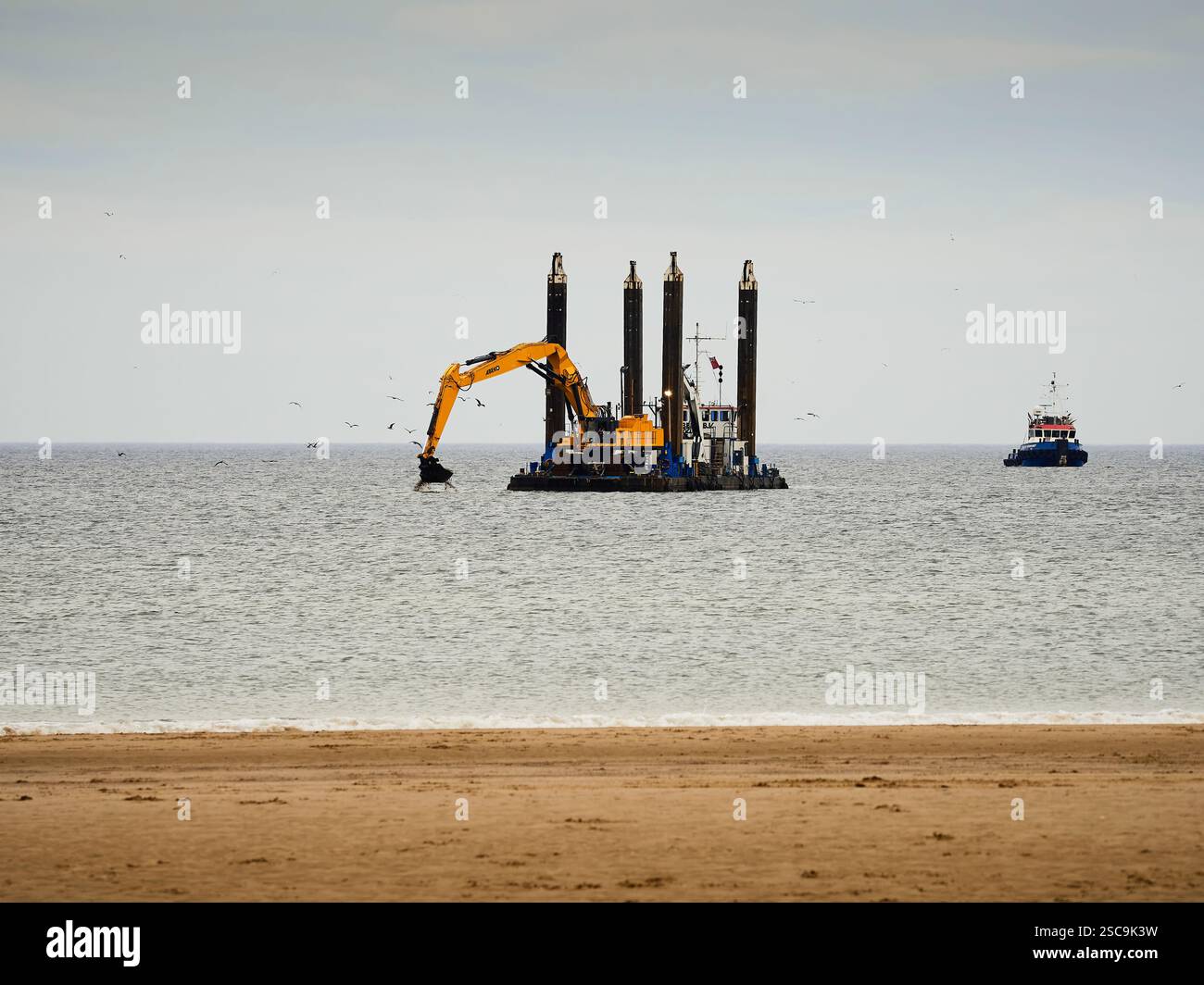 Dredger with scoop arm working inshore North Sea at Marske. North ...