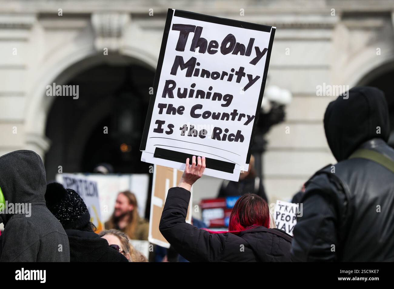A protester holds a placard outside of the Pennsylvania Capitol during ...
