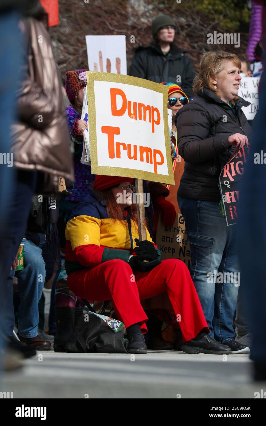 A protester holds a placard outside of the Pennsylvania Capitol during ...