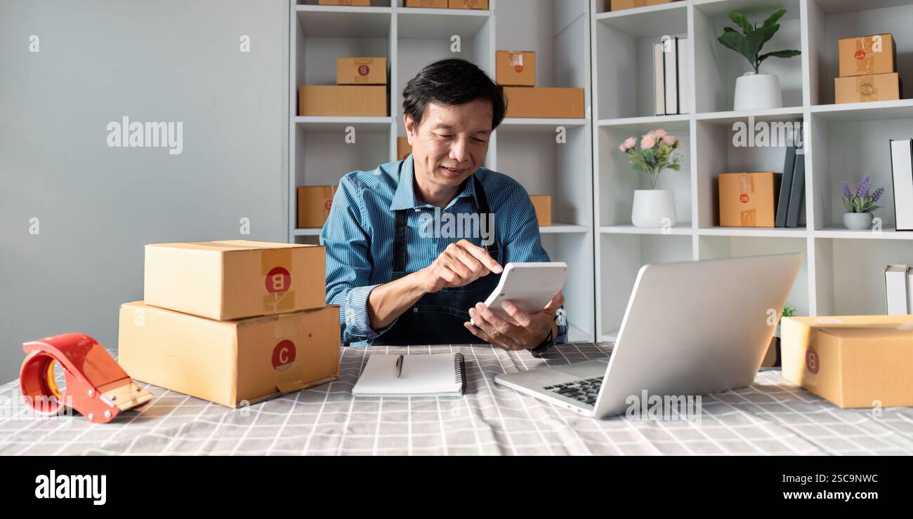E-commerce entrepreneur managing online sales using a smartphone and ...