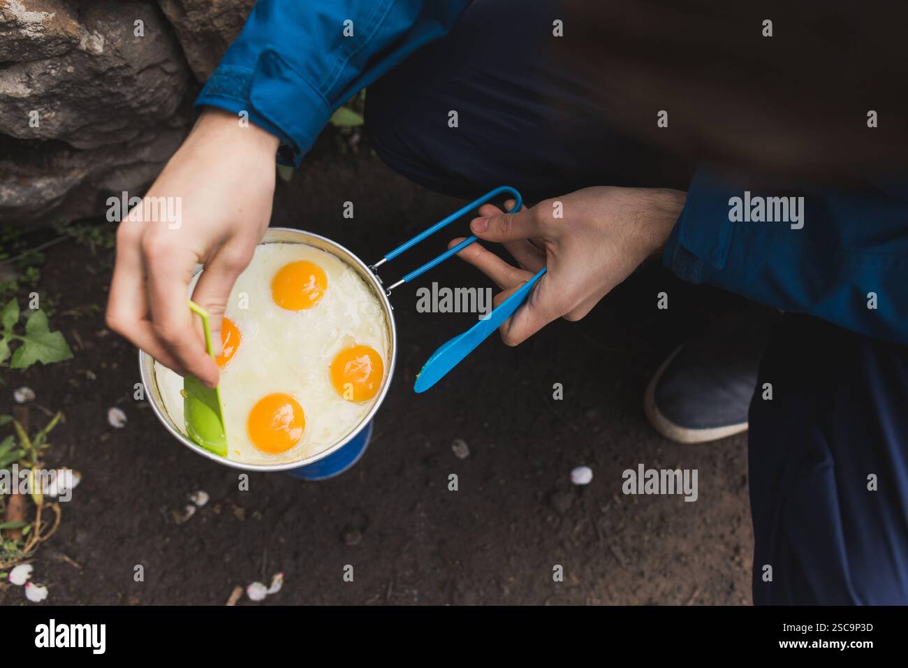 Four eggs cooking in a pan, camping Stock Photo - Alamy