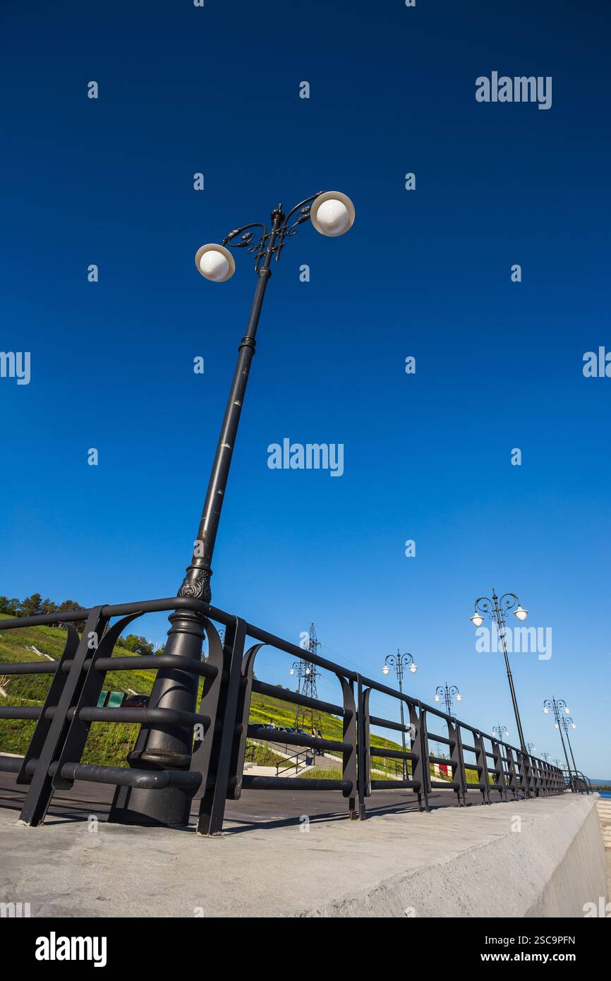 Street lights on the promenade on the shore of the great river Stock ...