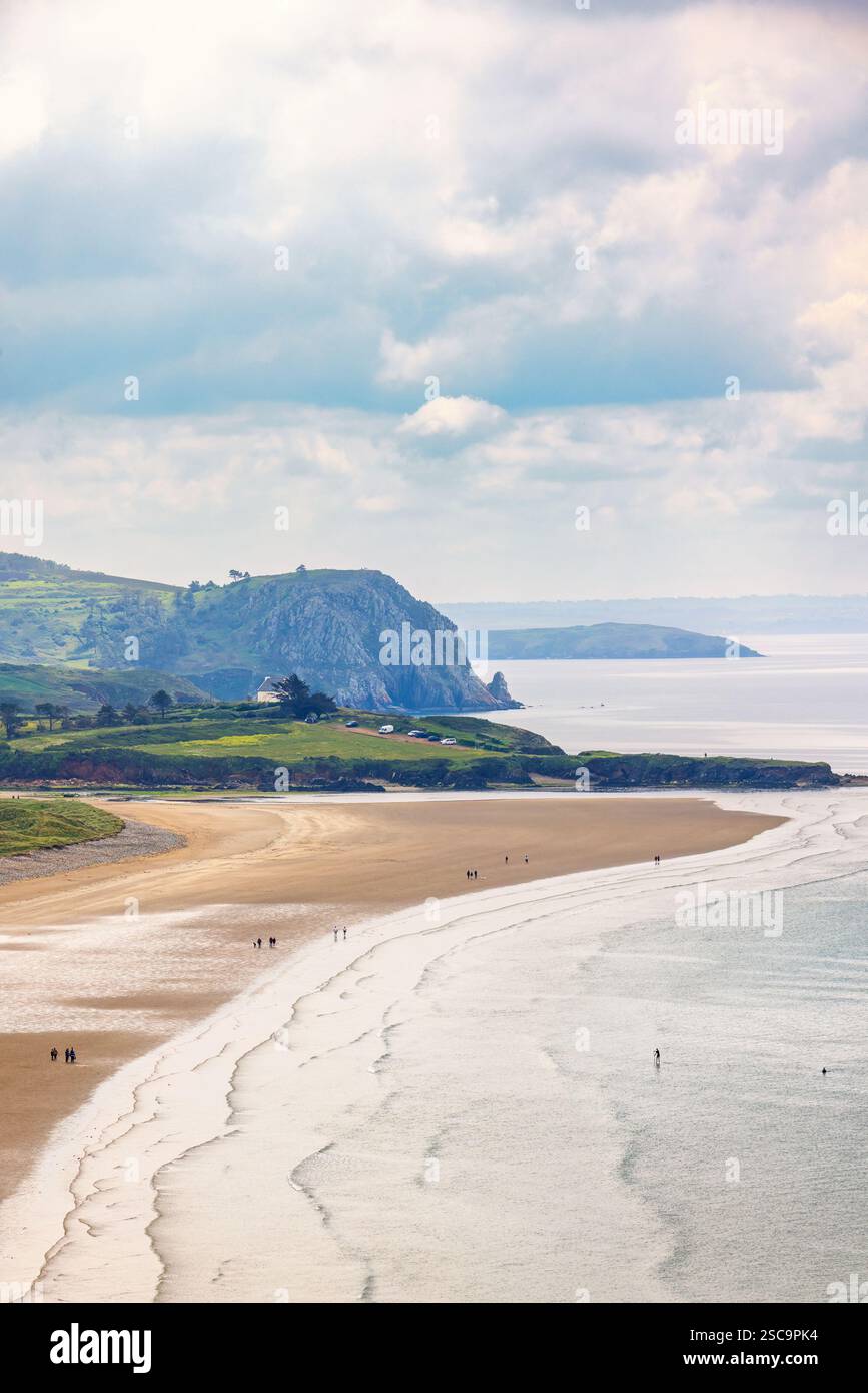 Aerial view at a sand beach with rolling waves in a rocky coastline in ...