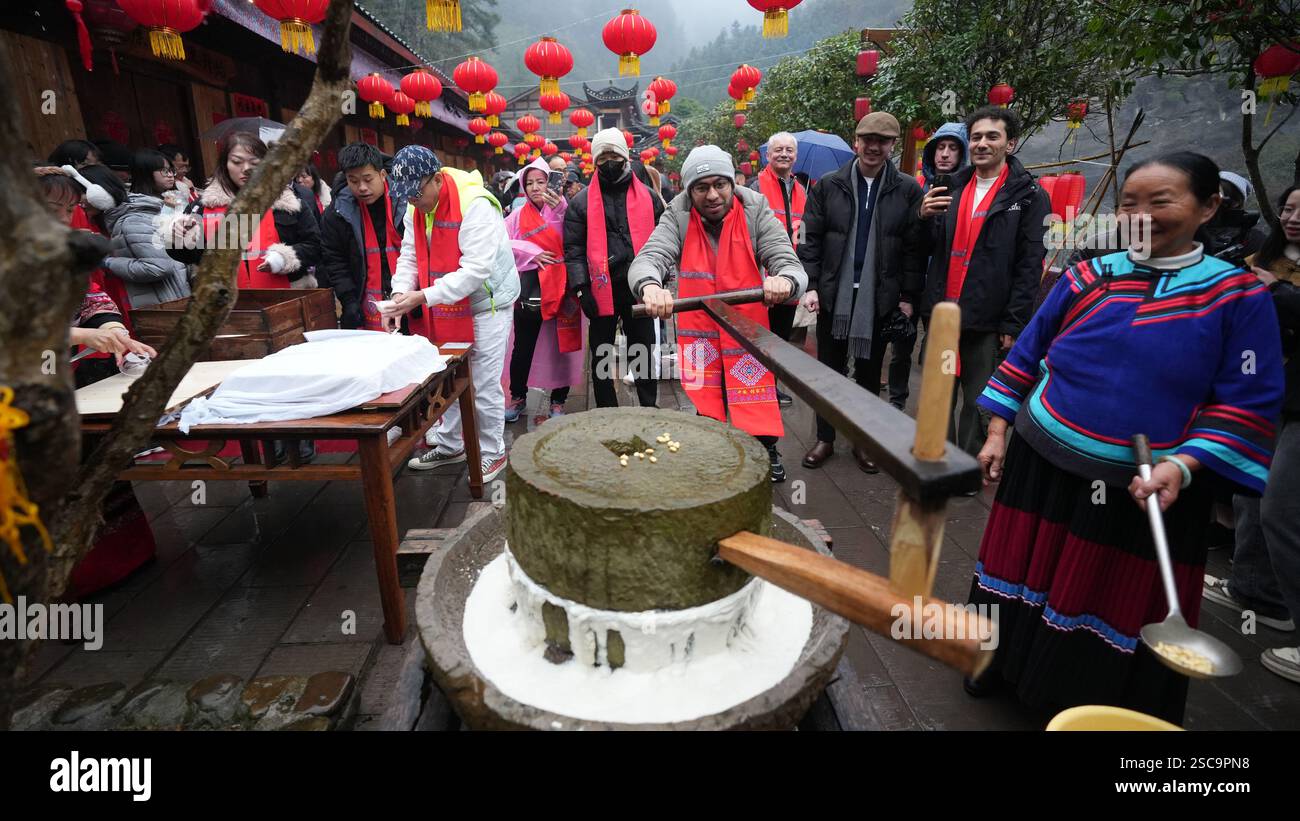 Beijing, China's Hunan Province. 24th Jan, 2025. Foreign tourists try ...