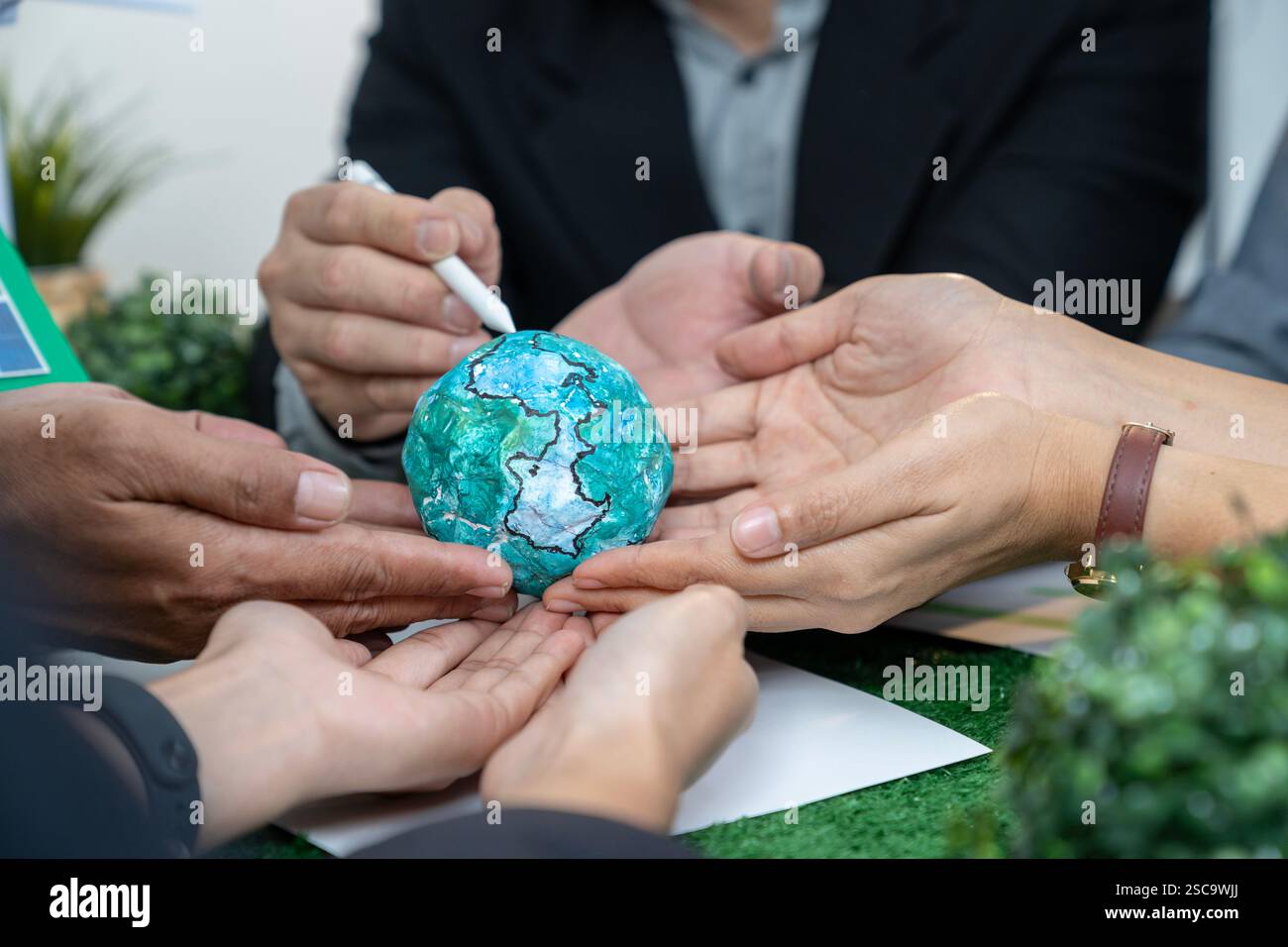 Hands business Team Work Cupping young Plant Nurture Environmental and reduce global warming ...