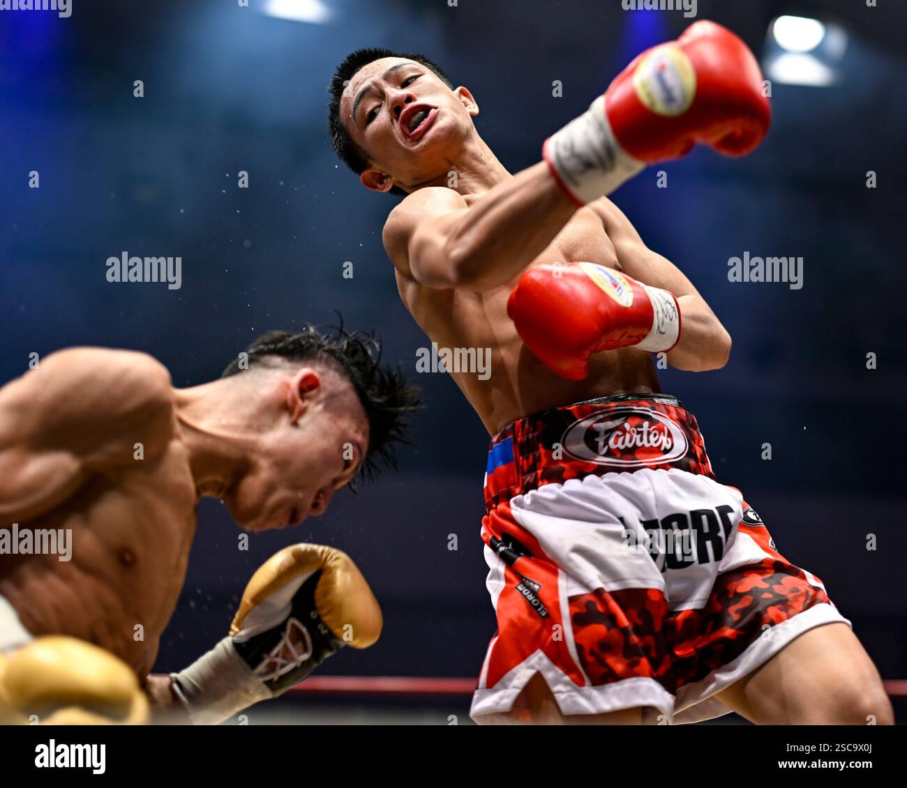 Tokyo, Japan. 18th Jan, 2025. Philippines' Lorenz Dumam-ag (red golves) throws a right at Japan ...