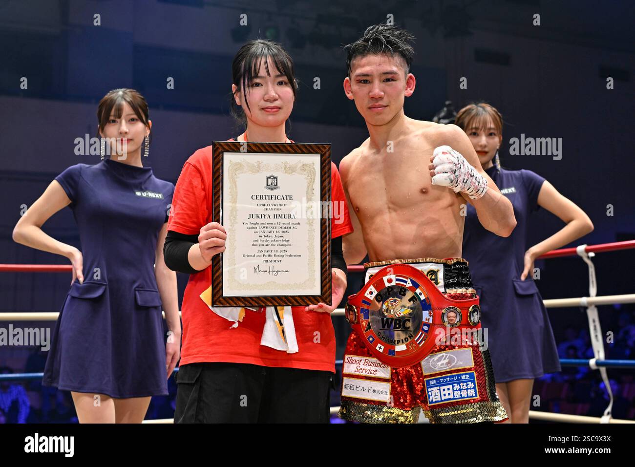 Japan's Jukiya Iimura, right, poses with his wife Manami after winning the vacant OPBF Flyweight ...