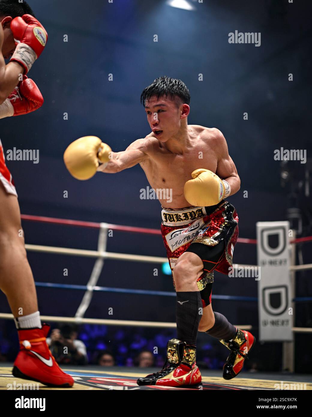 Japan's Jukiya Iimura (gold gloves) throws a right at Philippines' Lorenz Dumam-ag (red golves ...