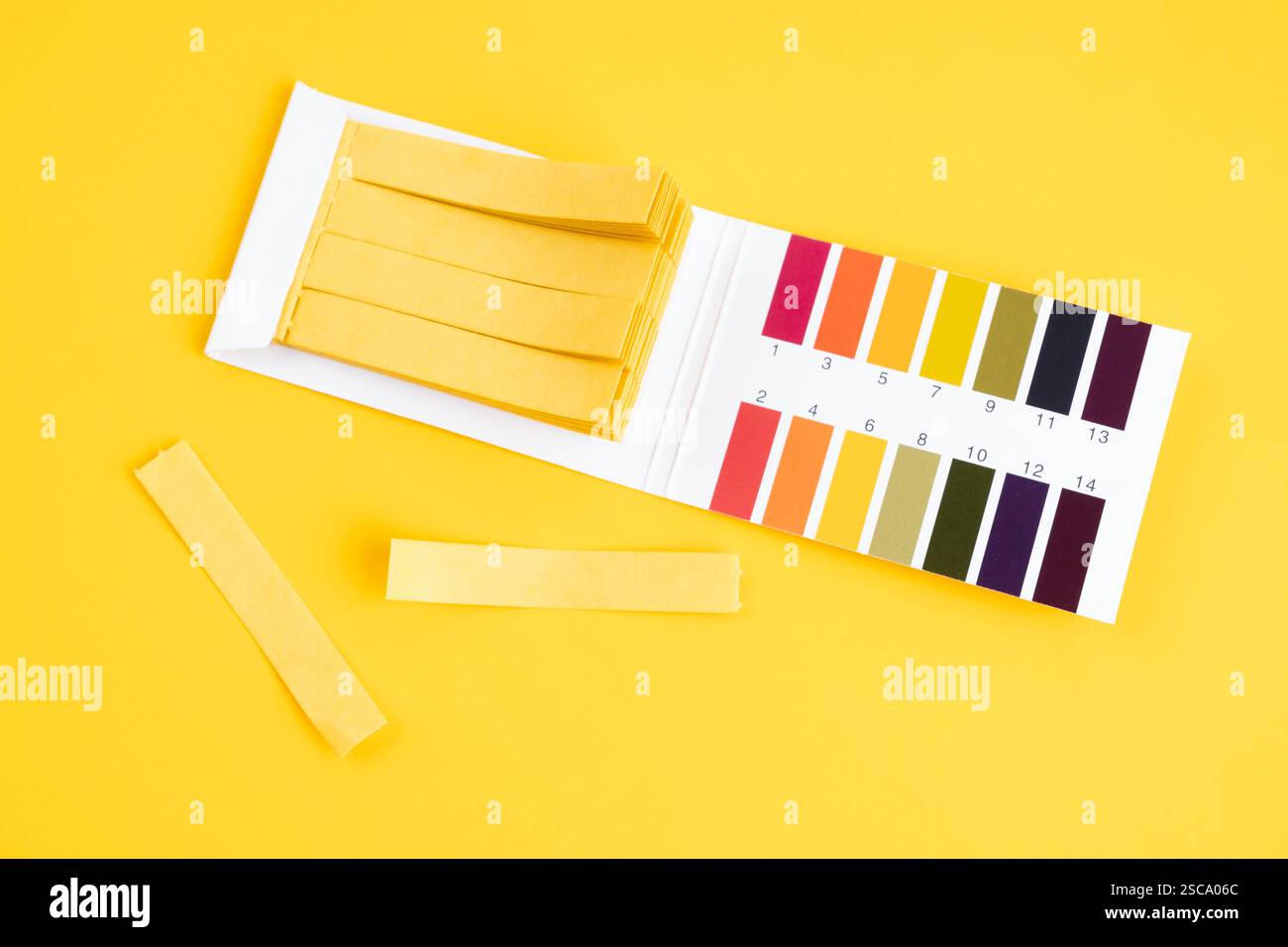 universal indicator paper with acidic testing on yellow background ...