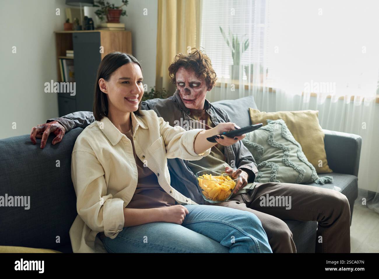 Unusual Couple Choosing Movie On TV Stock Photo - Alamy