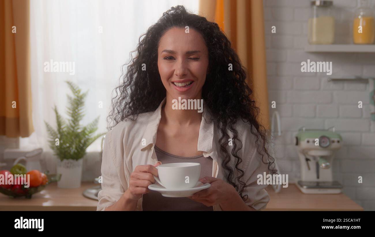 Hispanic Caucasian woman girl female kitchen home enjoying drinking aroma tea coffee herbal ...