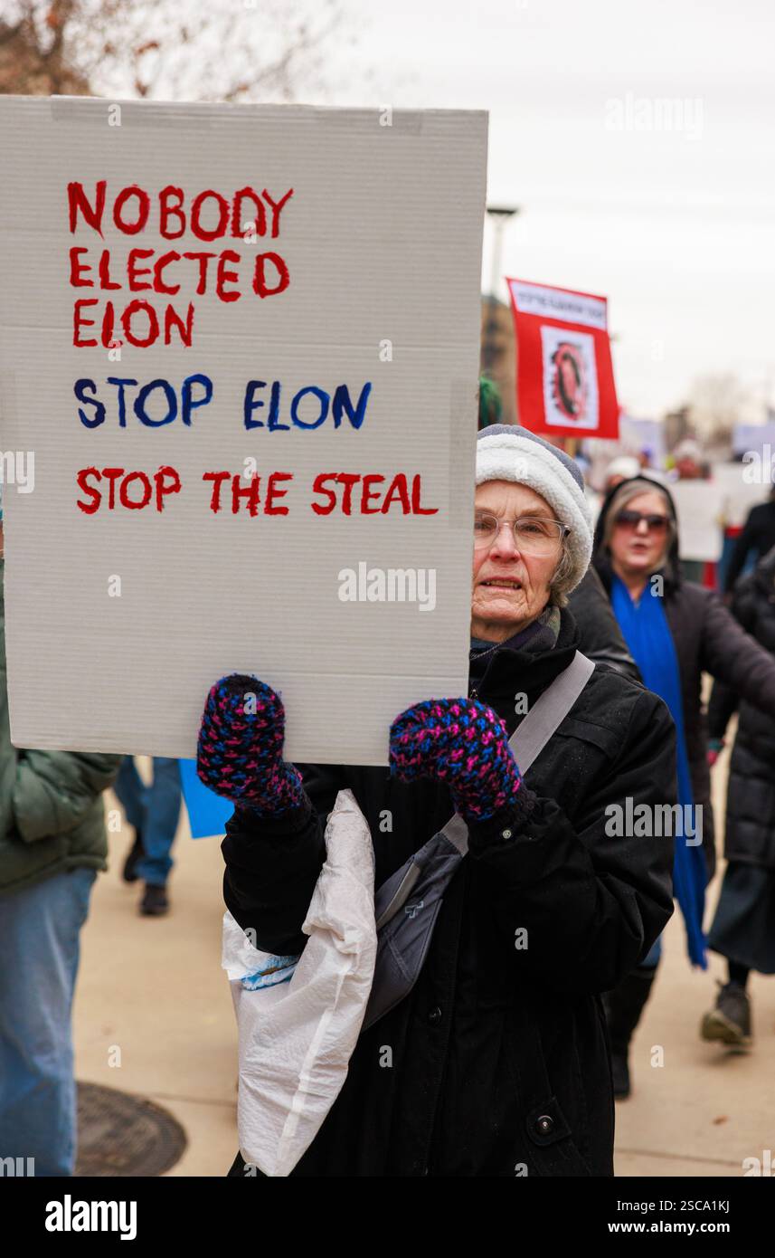 A demonstrator holds a sign that reads, “Nobody Elected ELON stop Elon ...