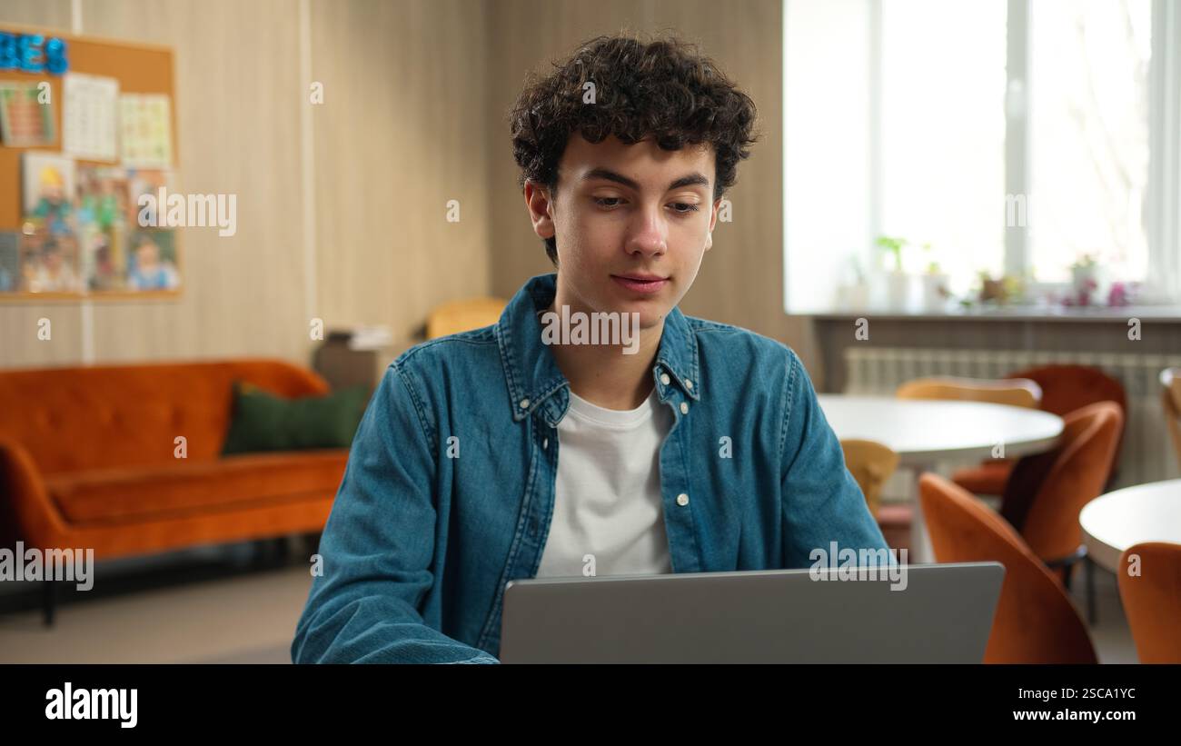 Caucasian male student guy pupil boy teen teenager studying laptop ...