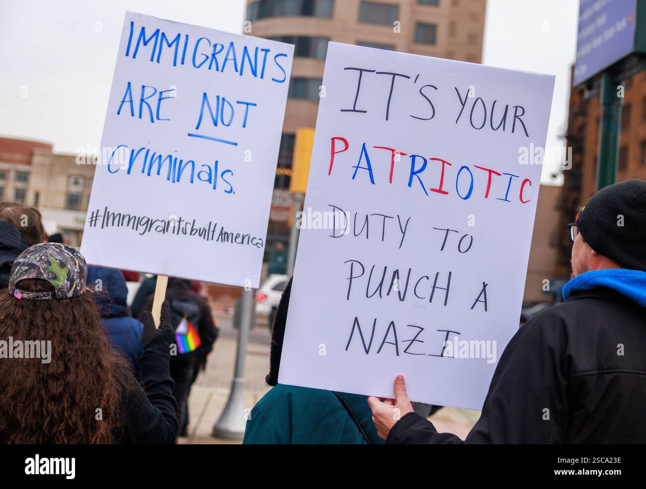 A demonstrator holds a sign that reads, “It's your patriotic duty to ...