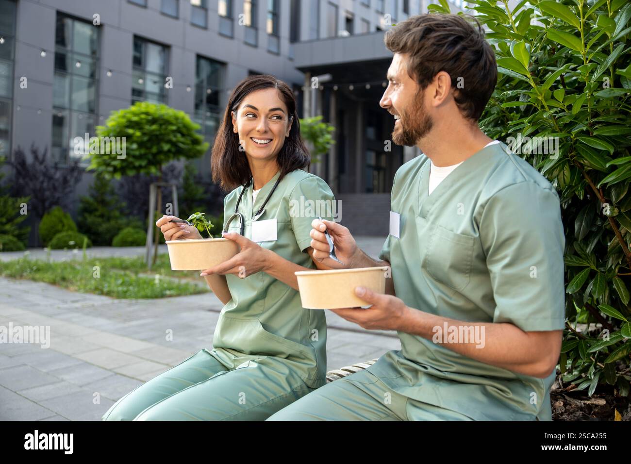 Two doctors having lunch together in the clinic yard Stock Photo - Alamy