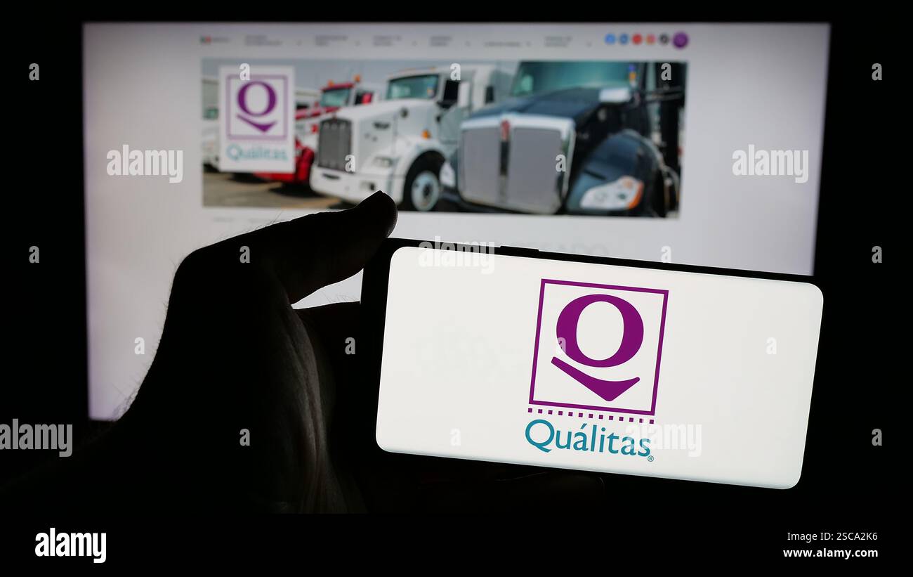 In this photo illustration, a person is holding a mobile phone with the ...