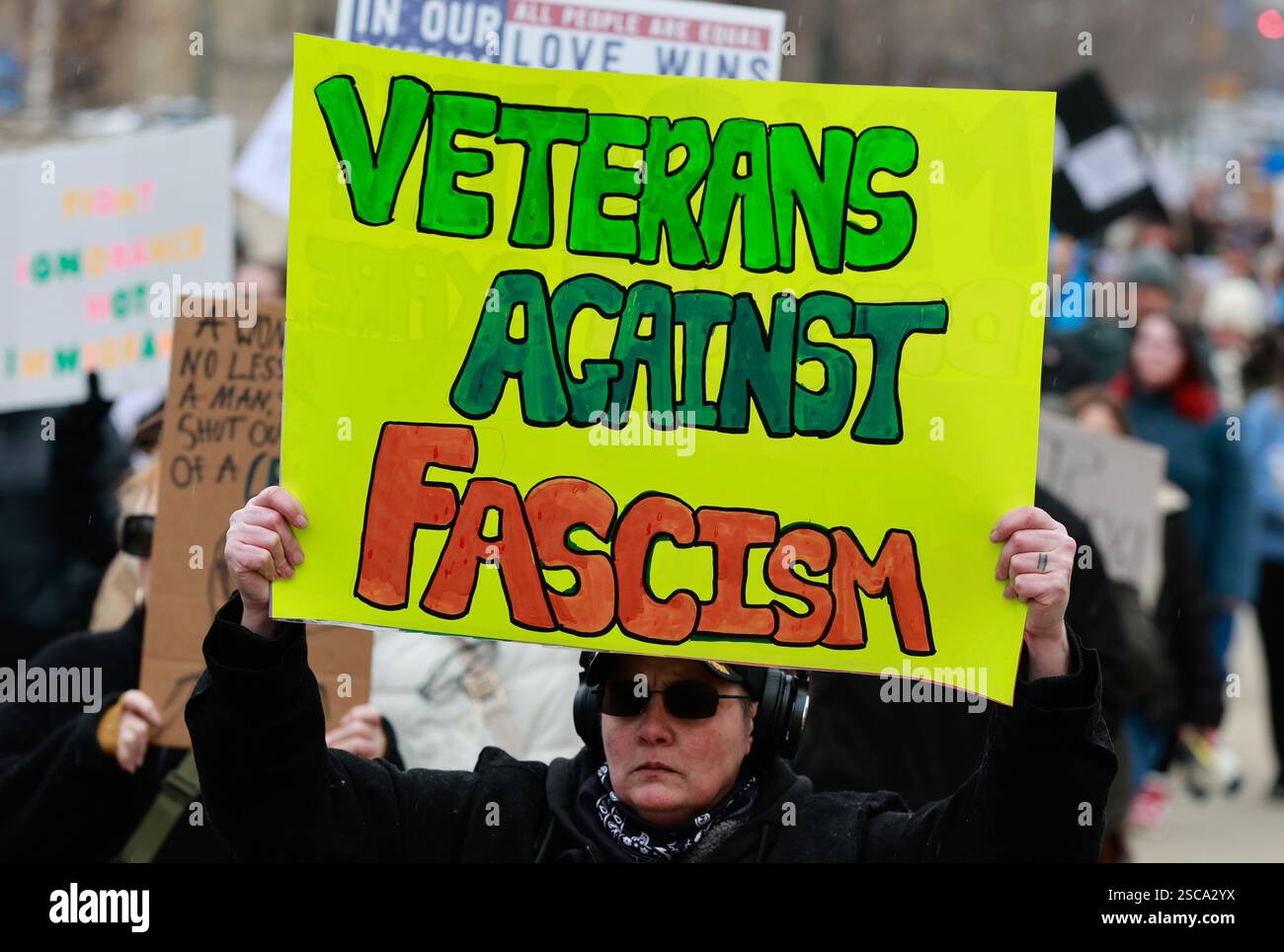 A demonstrator holds a sign that reads, “Veterans Against Fascism ...