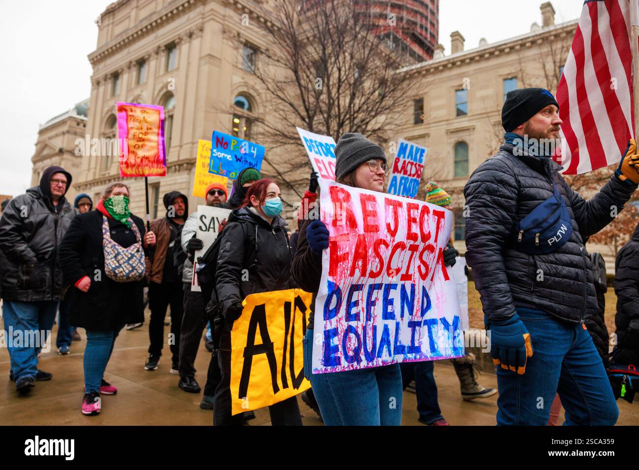 A demonstrator holds a sign that reads, “Reject Fascism Defend Equality ...