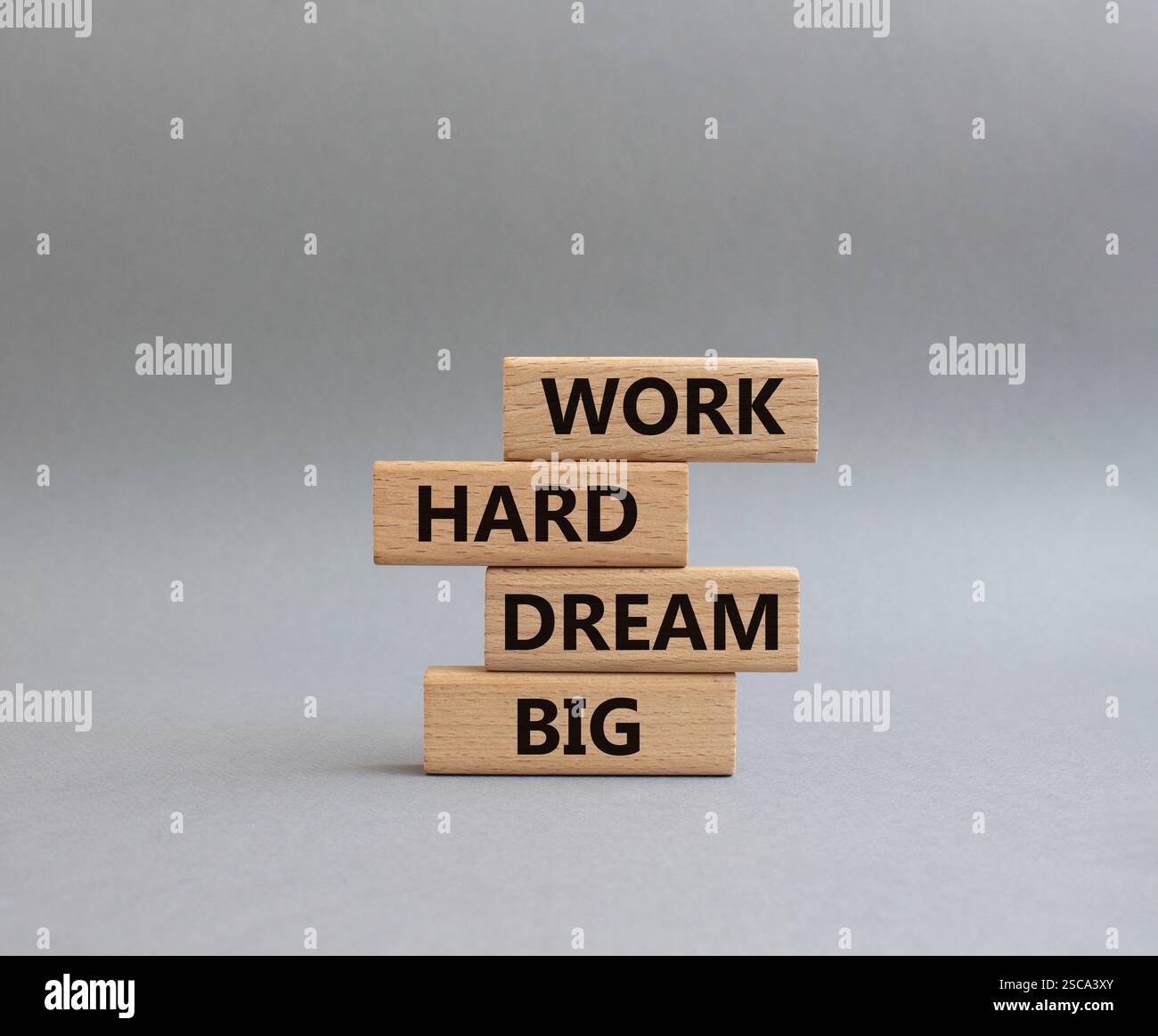 Work and dream symbol. Wooden blocks with words 'Work Hard Dream Big ...