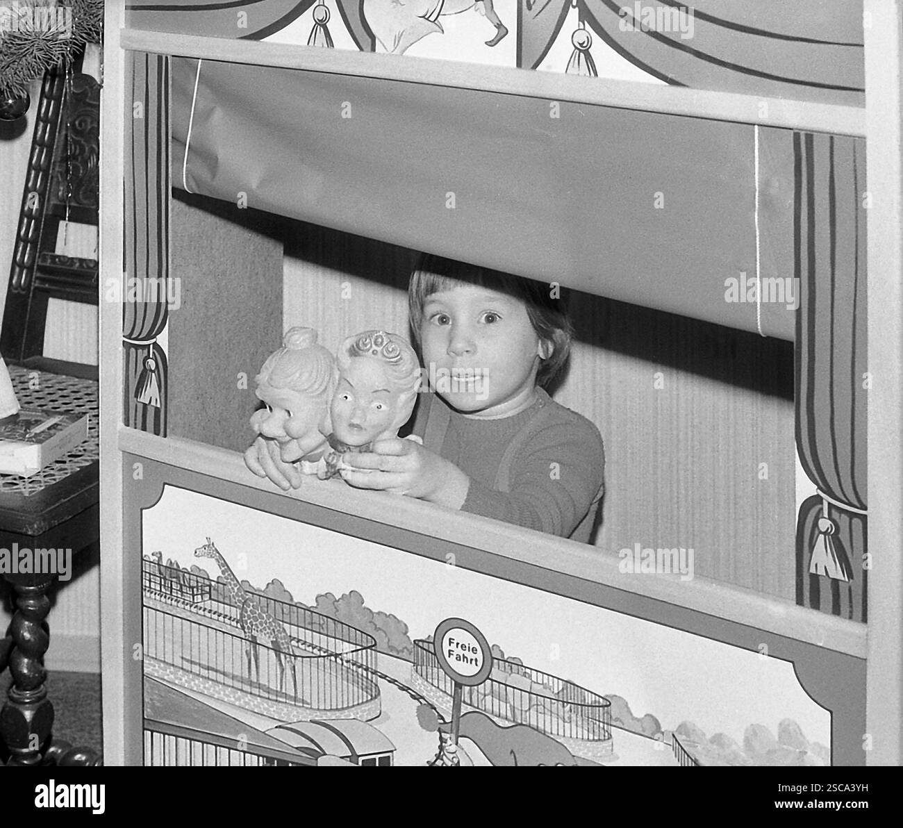 Christmas present puppet theater: Child plays with puppets in a puppet ...
