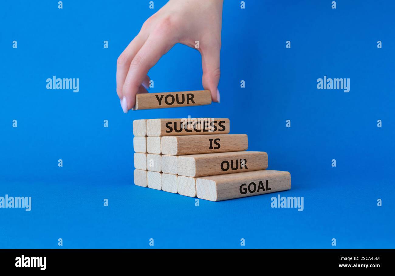 Your success is our goal symbol. Wooden blocks with words Your success is our goal. Beautiful ...