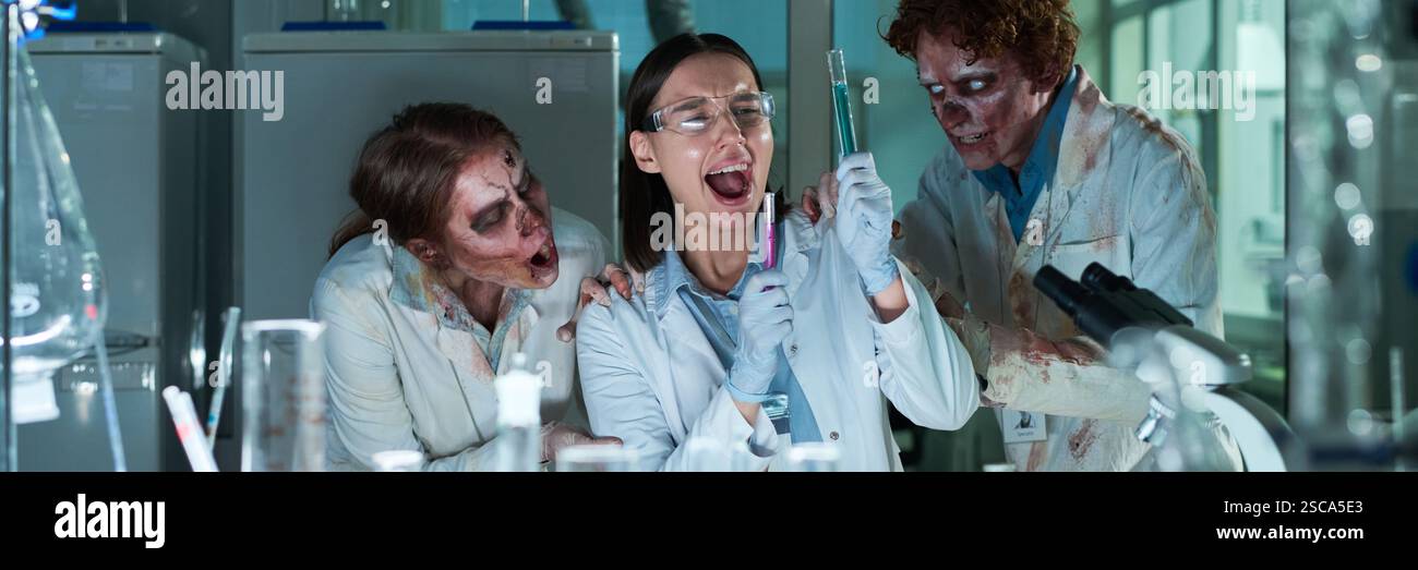 Zombies Attacking Female Researcher In Lab Header Stock Photo - Alamy
