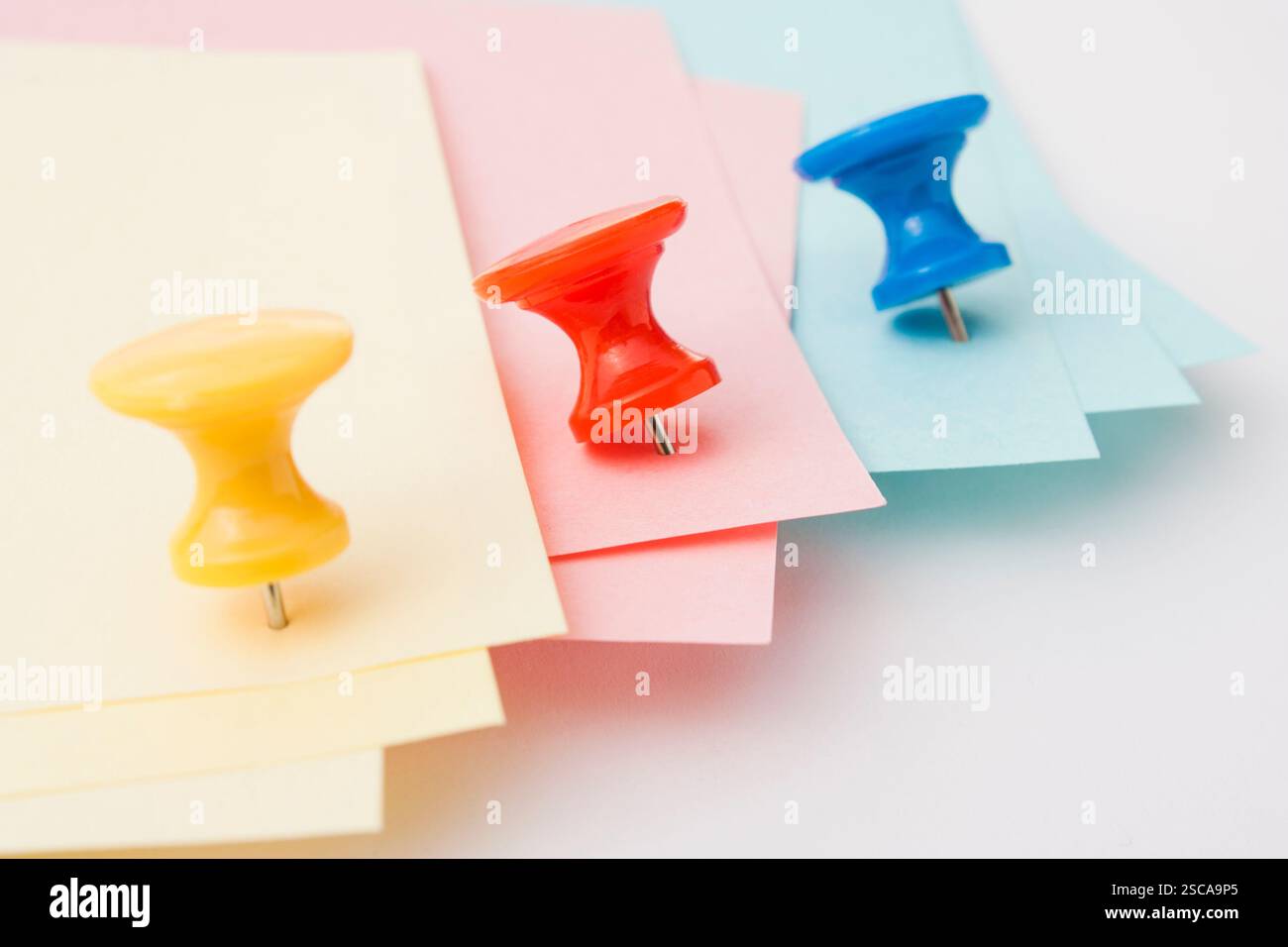 the sheets pinned buttons on white background Stock Photo - Alamy