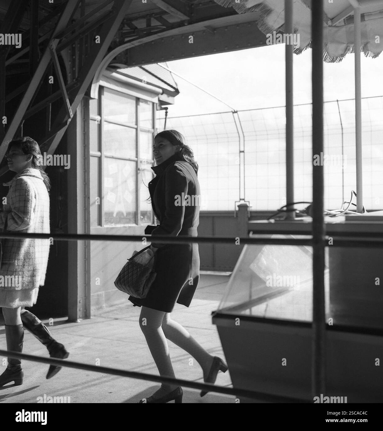 Women with coats and wind on top of the Eiffel Tower in Paris Stock ...