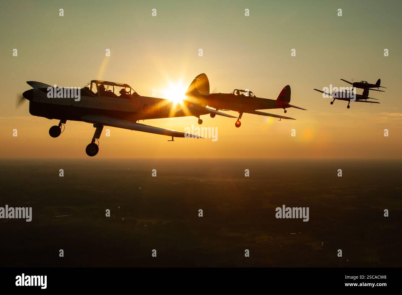 Four DHC-1 Chipmunk aircraft flying in a synchronized formation at ...