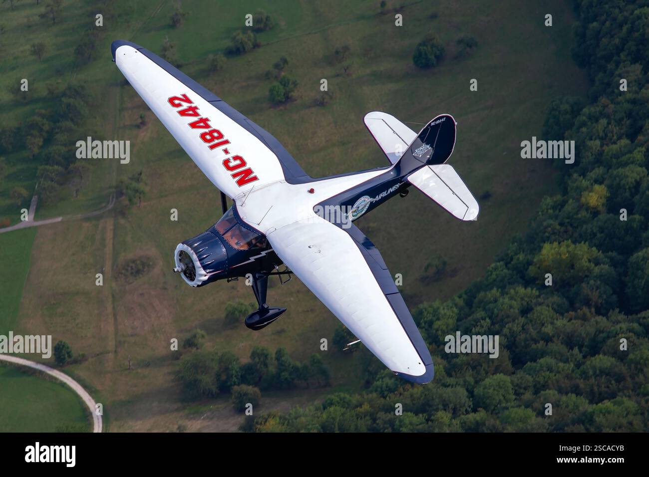 A Stinson Reliant aircraft performing a maneuver during an air-to-air ...