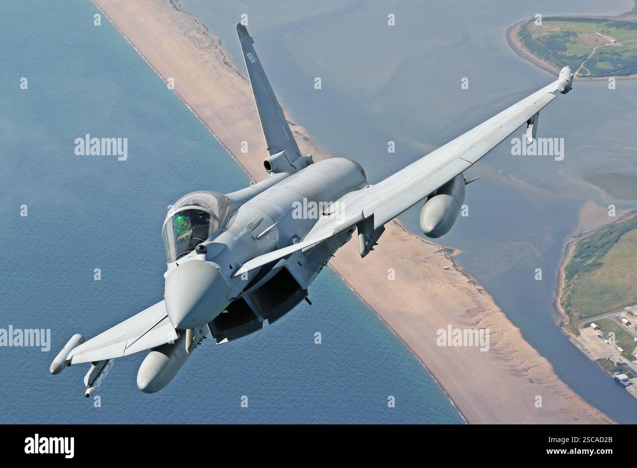 A Royal Air Force Eurofighter Typhoon performing aerial maneuvers during an air-to-air photo ...