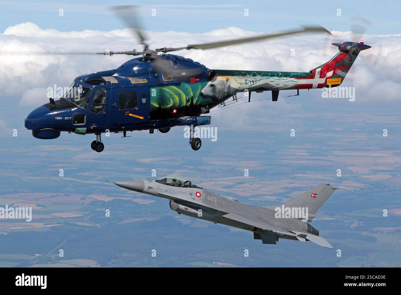 A Danish Air Force Lynx helicopter and F-16 Fighting Falcon in ...