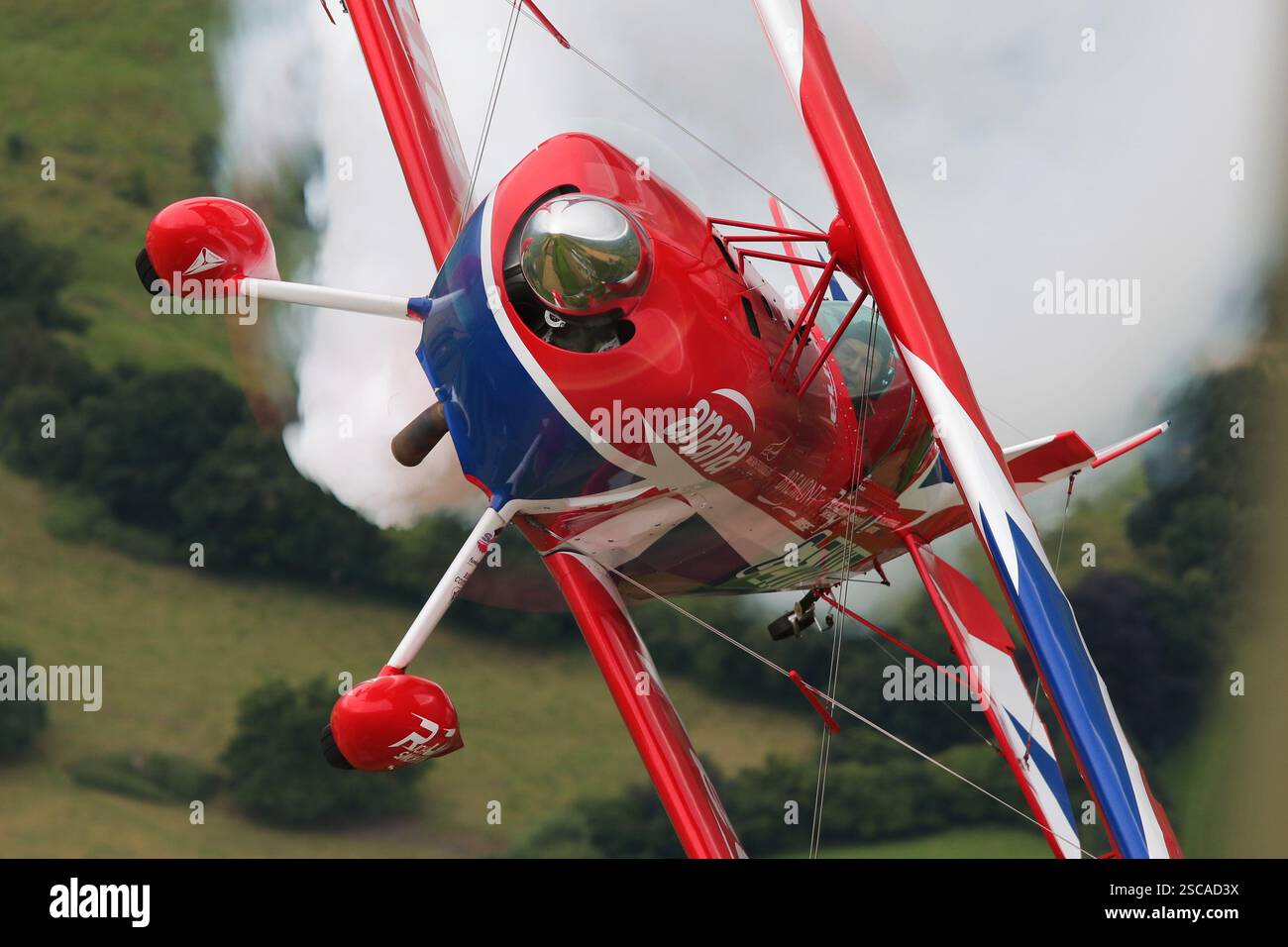 A Pitts Special aerobatic biplane performing a series of rolls and ...