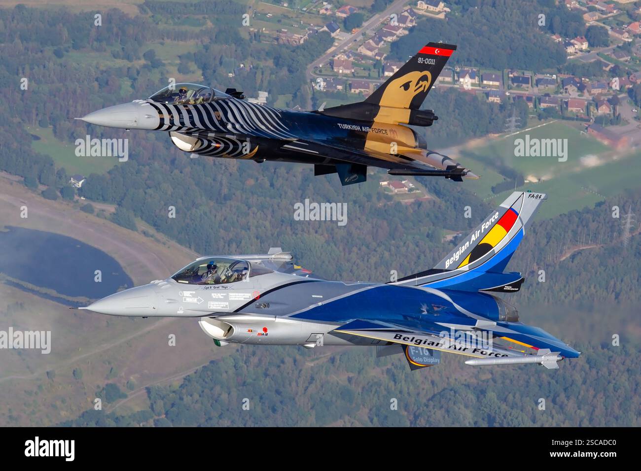 A formation of Belgian and Turkish F-16 fighter jets captured in flight ...