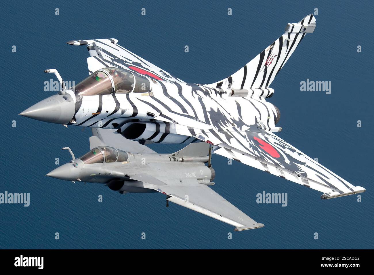 A French Navy Dassault Rafale performing a barrel roll in the skies ...