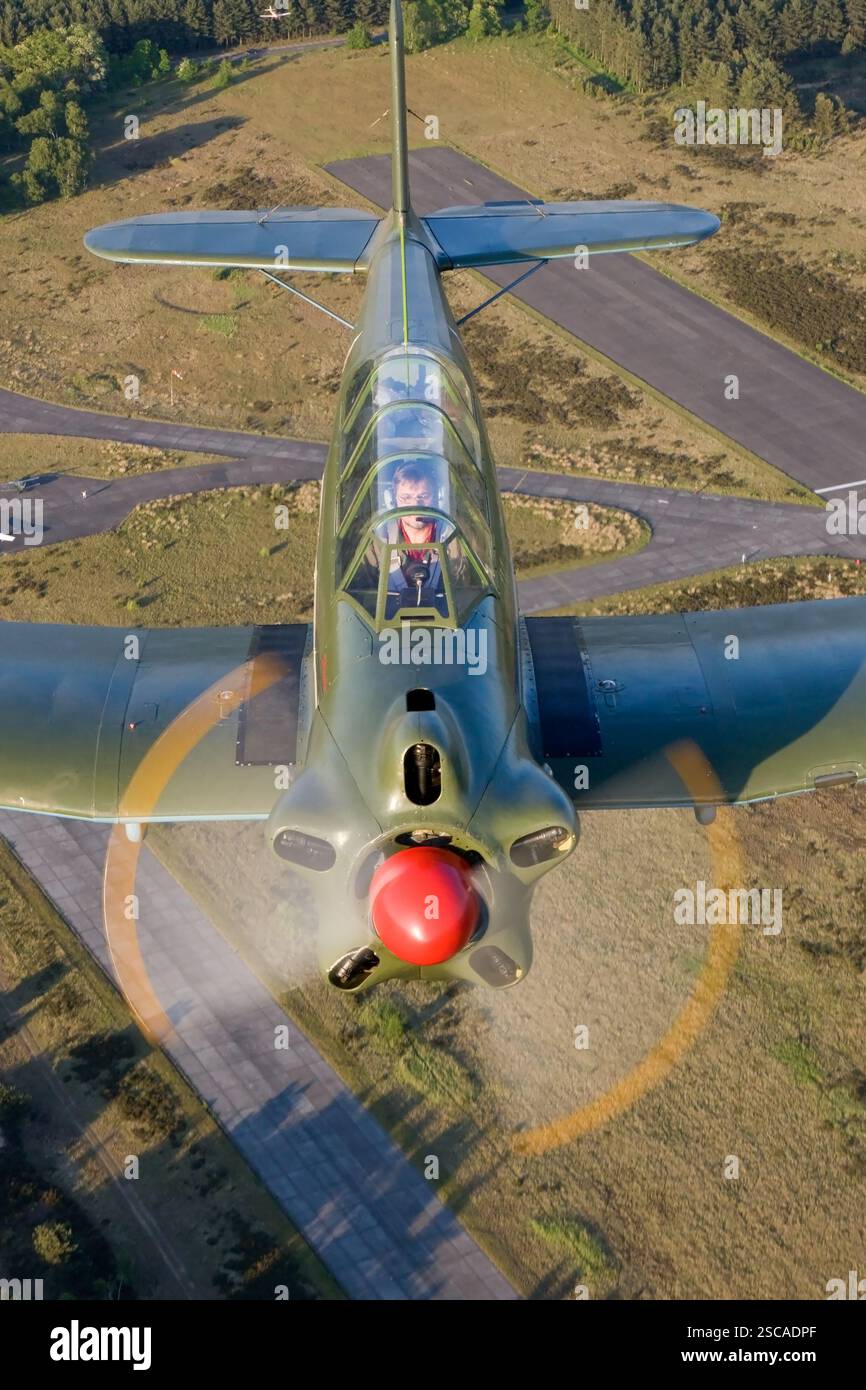 Yak-18 performing an air-to-air photo shoot in formation with other aircraft. The Yak-18 is a ...