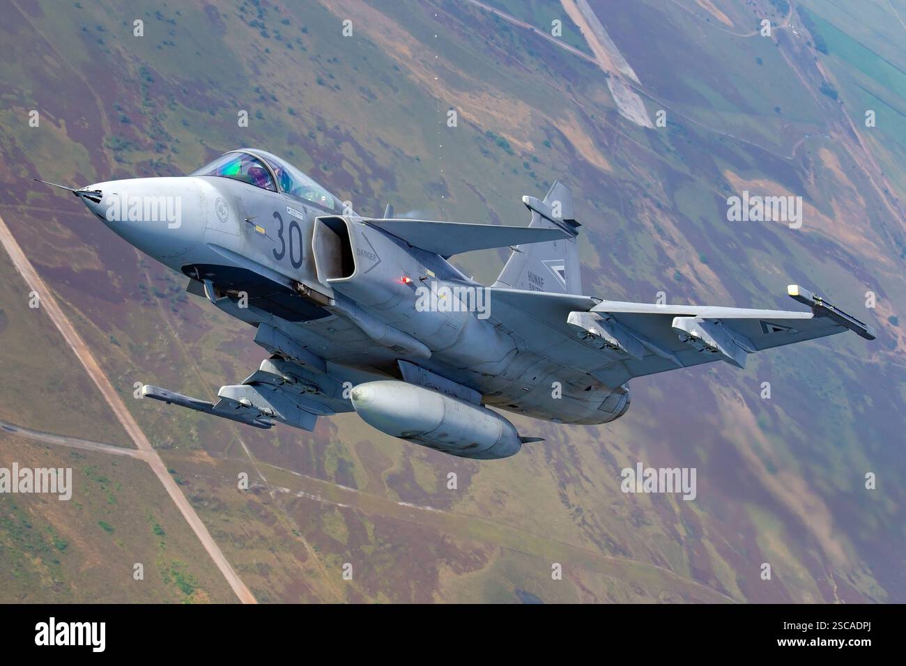 A Hungarian Air Force Saab JAS 39 Gripen performing an aerial maneuver ...